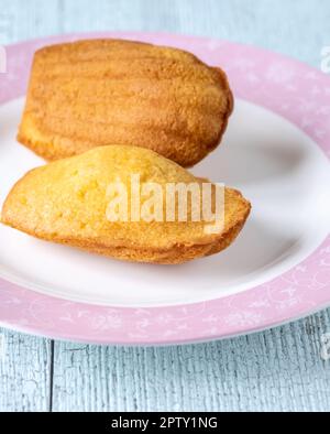 Madeleines - French small sponge cakes on the serving plate Stock Photo ...