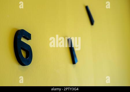 Six o'clock or numder six on yellow background Stock Photo - Alamy