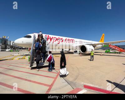 People climb the ramp to the plane. Passengers are loaded into the ...