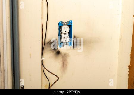 Electrical outlet with burn marks on wall from short circuit Stock ...