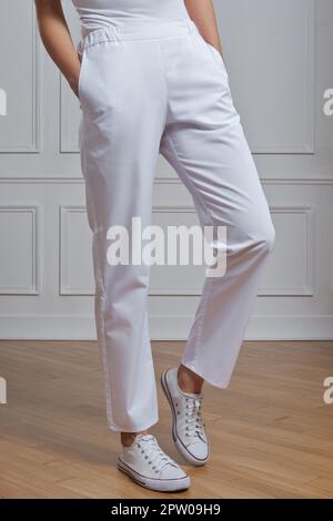 Female legs in medical pants and white sneakers. Medical uniform Stock ...