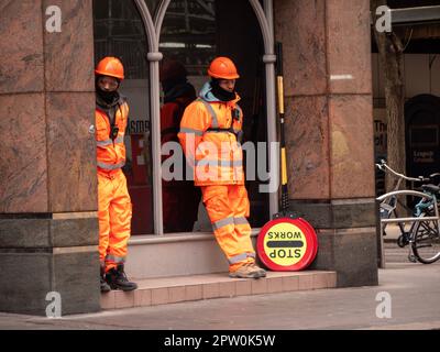 Banksman traffic marshall with fluorescent suit and helmet with stop ...