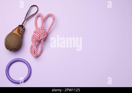 Textile toy, rope for playing with animals on a yellow background, top ...