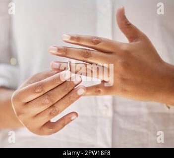 Closeup of a wife breaking up relationship leaving the wedding ring on ...