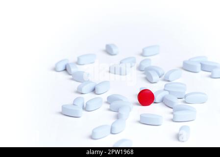Medication, placebo concept. Single red pill shown prominently among ...