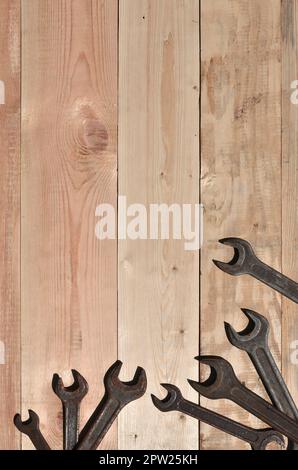 A few rusty spanners on a wooden background. Obsolete household tools ...