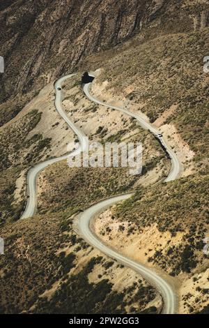 Narrow twisting dirt road across the Andes Mountains in Mendoza ...