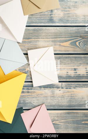 Multicolored envelopes lie randomly on gray wooden rustic textured ...