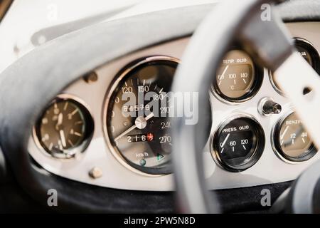 Close up hot of a vintage dashboard with various gauges on a retro car ...
