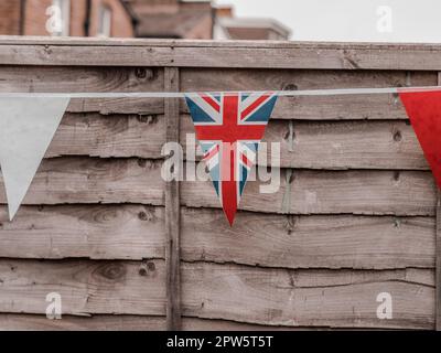 Flags of Great Britain waving on the wind in the garden of English ...
