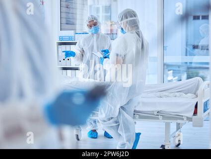 Biohazard team moving a dead body in a hospital bed. Team of doctors ...