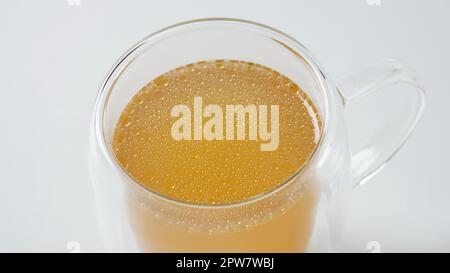 Chicken bone broth in transparent glass cup Stock Photo - Alamy
