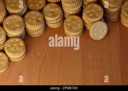 Background image of classic salty cracker on a brown wooden table with ...