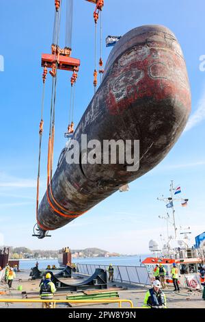 Kiel, Germany. 28th Apr, 2023. The submarine U17 is loaded onto a ...