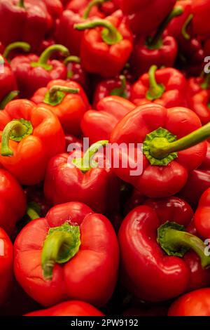Big pile of red peppers in a store Stock Photo - Alamy
