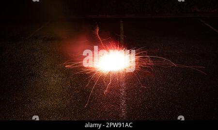 Red ground fireworks on asphalt Stock Photo - Alamy
