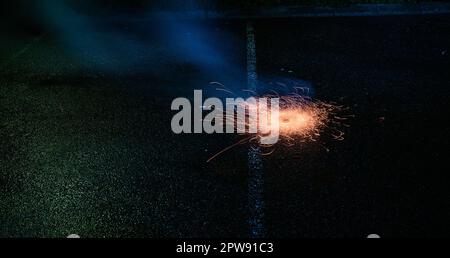 Yellow ground fireworks on asphalt exploding Stock Photo - Alamy