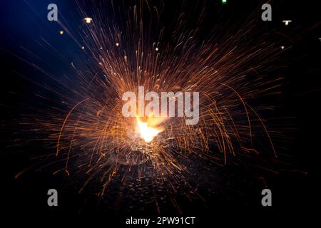 Yellow ground fireworks on asphalt exploding Stock Photo - Alamy