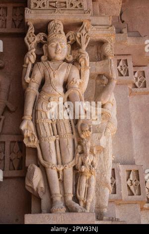 hindu god unique idol engraved art on temple wall from flat angle at ...