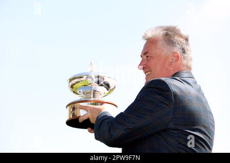 Paul Nicholls receives the champion trainer trophy alongside son Henry ...