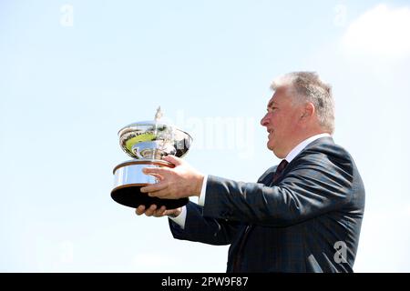 Paul Nicholls receives the champion trainer trophy alongside son Henry ...