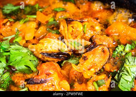 Charru Mussel, known in Brazil as a sururu moqueca, on white wooden ...