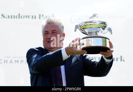 Paul Nicholls receives the champion trainer trophy alongside son Henry ...