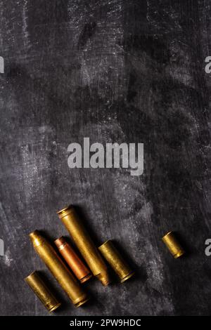 Empty bullet cartridges lying on the black background Stock Photo - Alamy