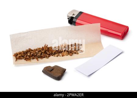Ingredients for a joint with a piece of afghan hash isolated on white ...