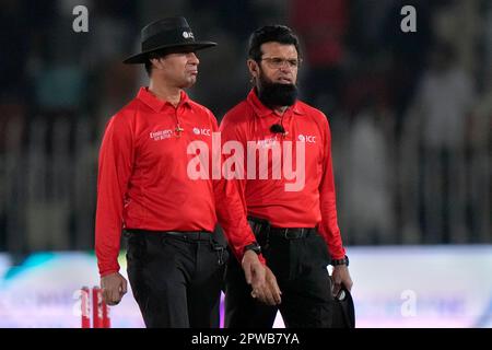 Pakistan's umpire Aleem Dar, right, walks off the field with his ...