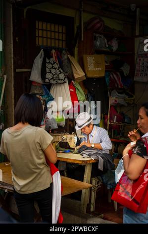 Filipino tailors working hard altering clothes, Manila, The Philippines ...