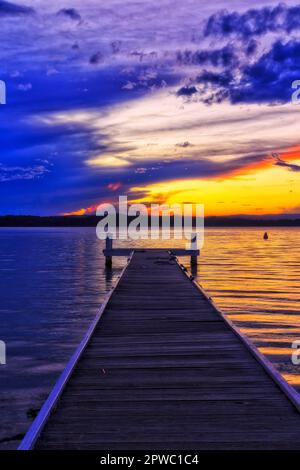 Timber boat jetty on Murrays beach lakeshore in Lake Macquarie at ...