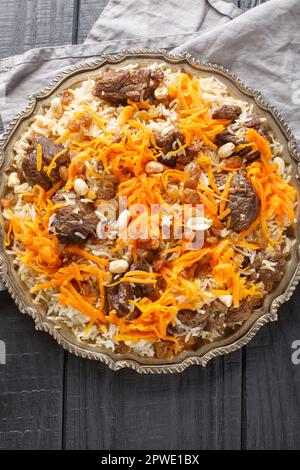 Traditional Kabuli Pulao with Sweet Carrot and raisins topping closeup ...