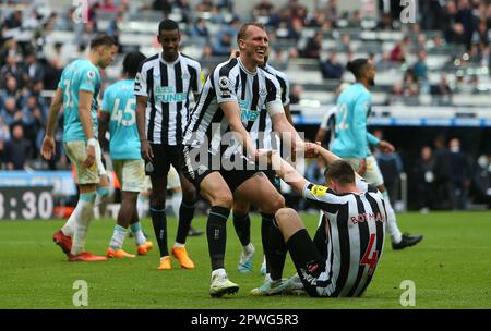 Newcastle United's Dan Burn lifts the trophy up as he and his team ...