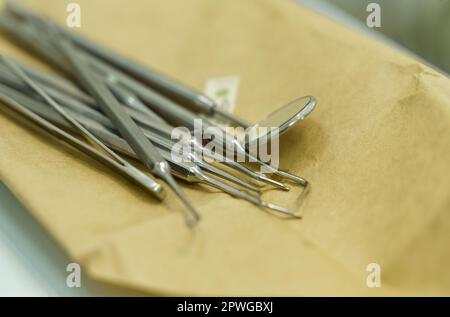 Dental instruments lie on wrapping paper before use. Close-up Stock ...