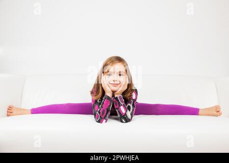 Cute little girl making splits Stock Photo - Alamy