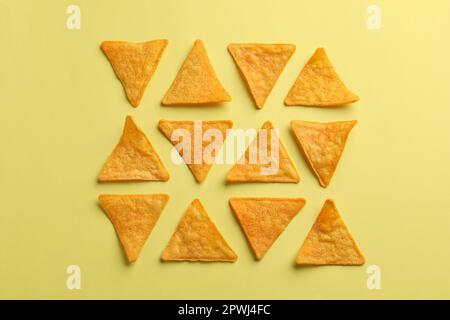 Flat lay composition of tortilla chips (nachos) on yellow background ...