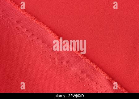 Straight neat undone seam of bright red fabric for clothes Stock Photo ...