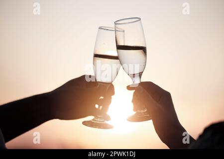 Heres to happy ever afters. a young couple making a toast while on a ...