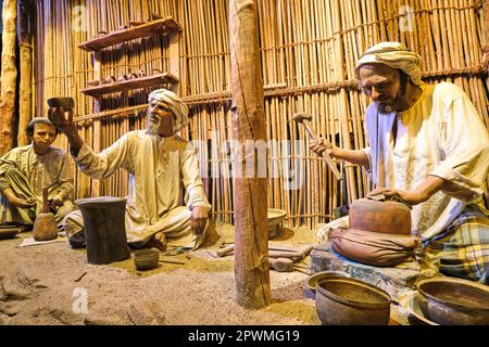Craftsmen busy stamping, hammering metal, bronze bowls, handicrafts. A ...