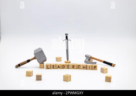 The wooden cubes with the word LEADERSHIP and the weapon around against ...
