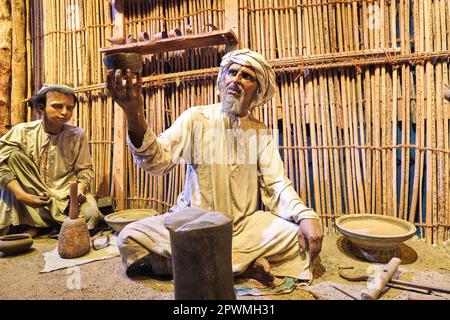 Craftsmen busy stamping, hammering metal, bronze bowls, handicrafts. A ...