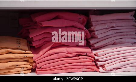 Stack of cloth different colors and sizes on the shelves in a clothes ...
