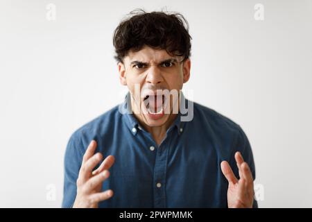 Angry man expressing aggression Stock Photo - Alamy