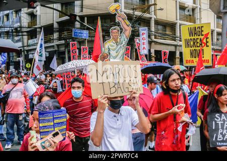 Union leaders, workers and activists hold signs and flags during the ...