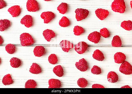 Tabletop view, raspberries spilled on white boards Stock Photo - Alamy