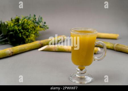 Fresh squeezed sugar cane juice with fresh cane sliced isolated on ...