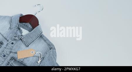 Gray denim shirt with empty tags on hanger on white background Stock ...