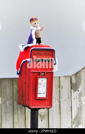 A coronation themed crocheted post box topper celebrating the ...