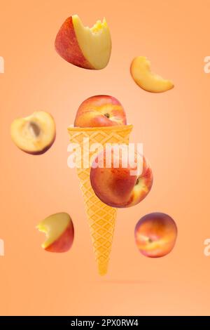 Falling ice cream cone with peach fruits. Seven flying whole peaches on ...